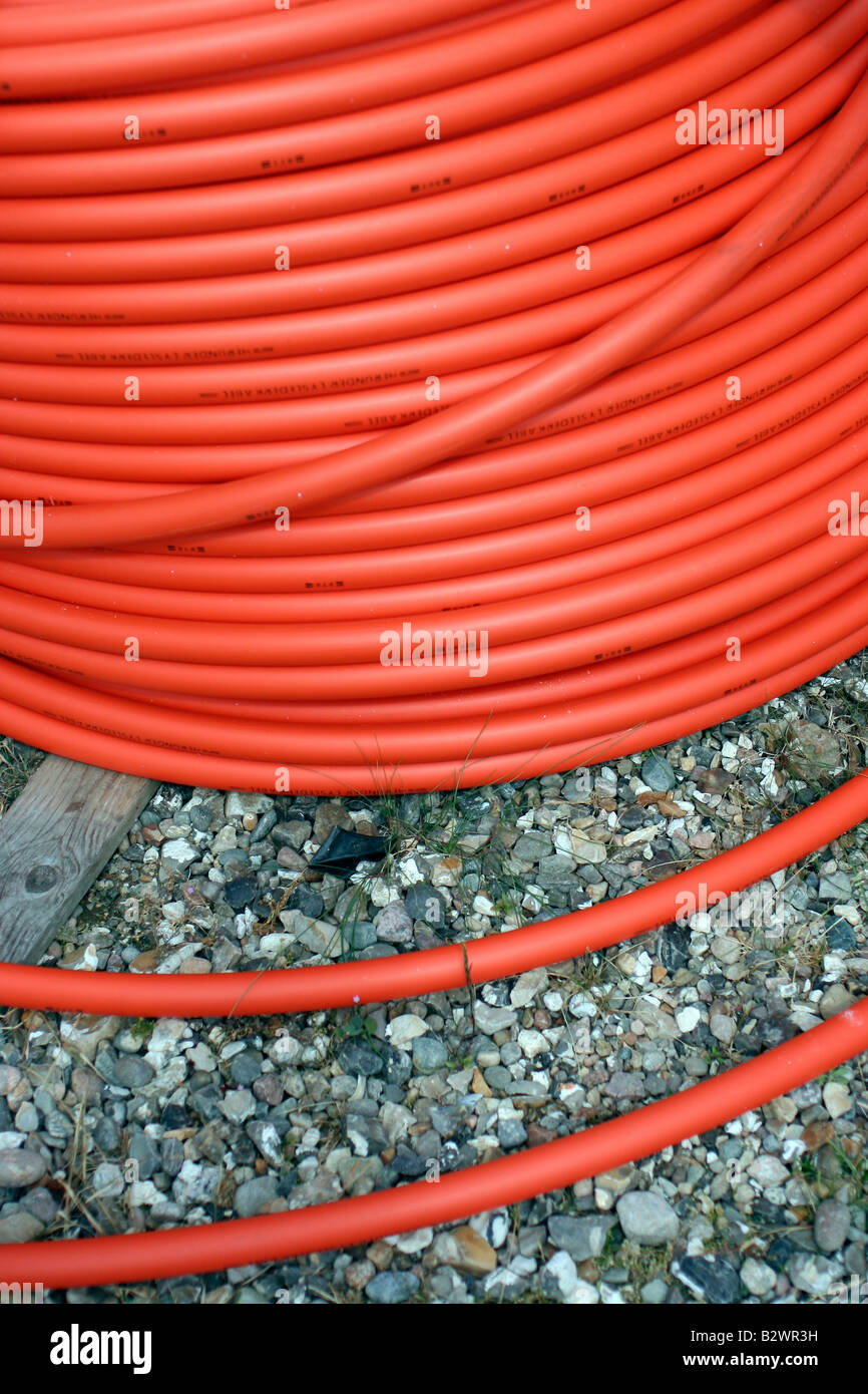 Red cable wound up on a reel Stock Photo - Alamy