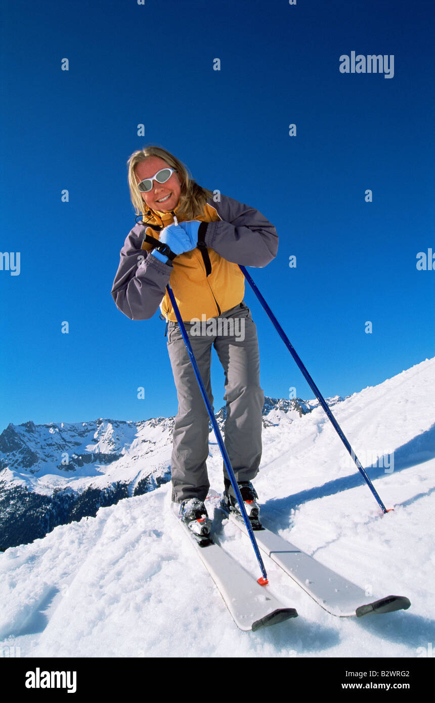 Skier standing on hill smiling Stock Photo - Alamy