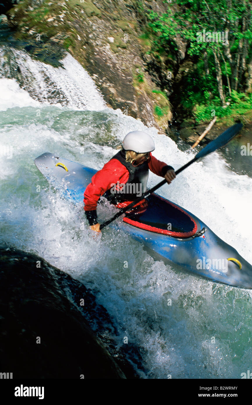 Kayaker in rapids going over waterfall (blur Stock Photo - Alamy