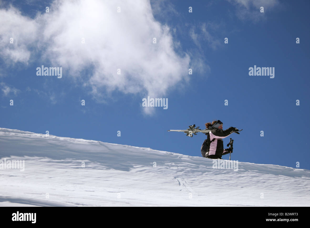A skier hikes above a cornice, off-piste in the Milky Way ski area of ...