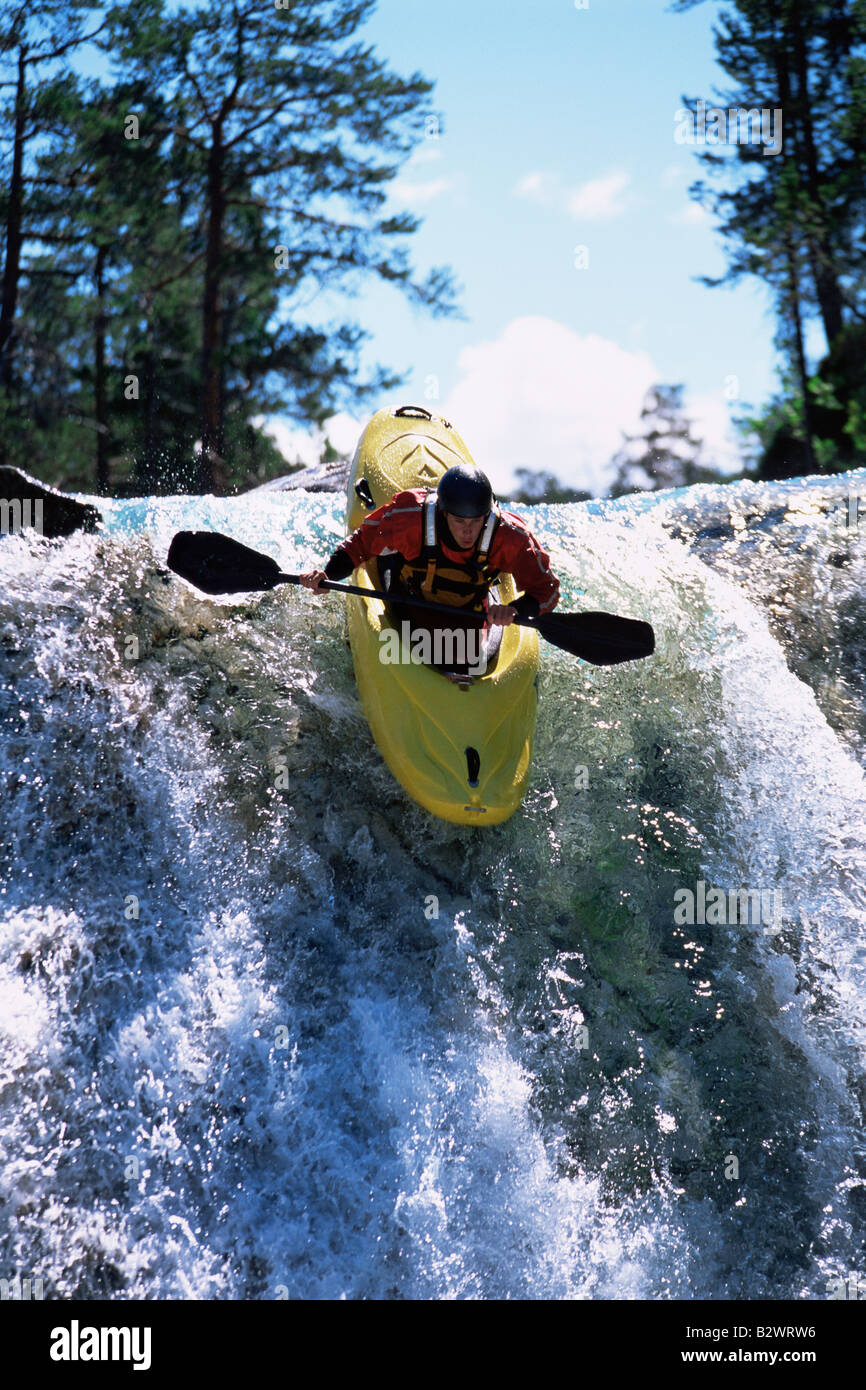 Kayaker in rapids going over waterfall (selective focus Stock Photo - Alamy