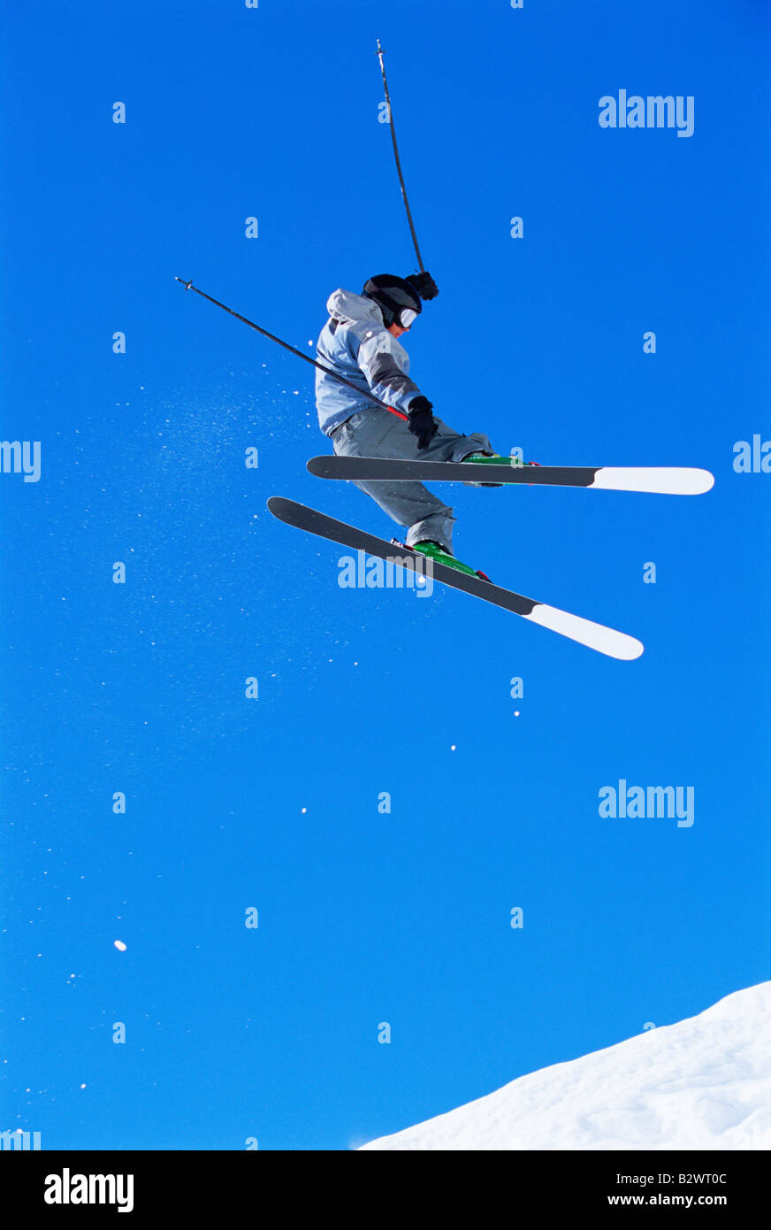 Skier doing jump on snowy hill Stock Photo - Alamy