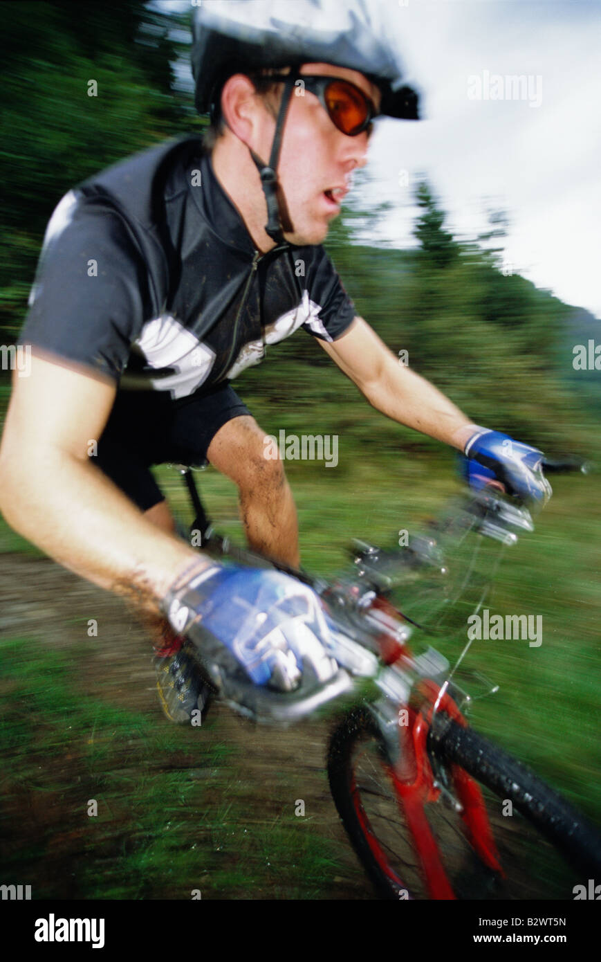 Man outdoors on trails riding bicycle (out of focus Stock Photo - Alamy