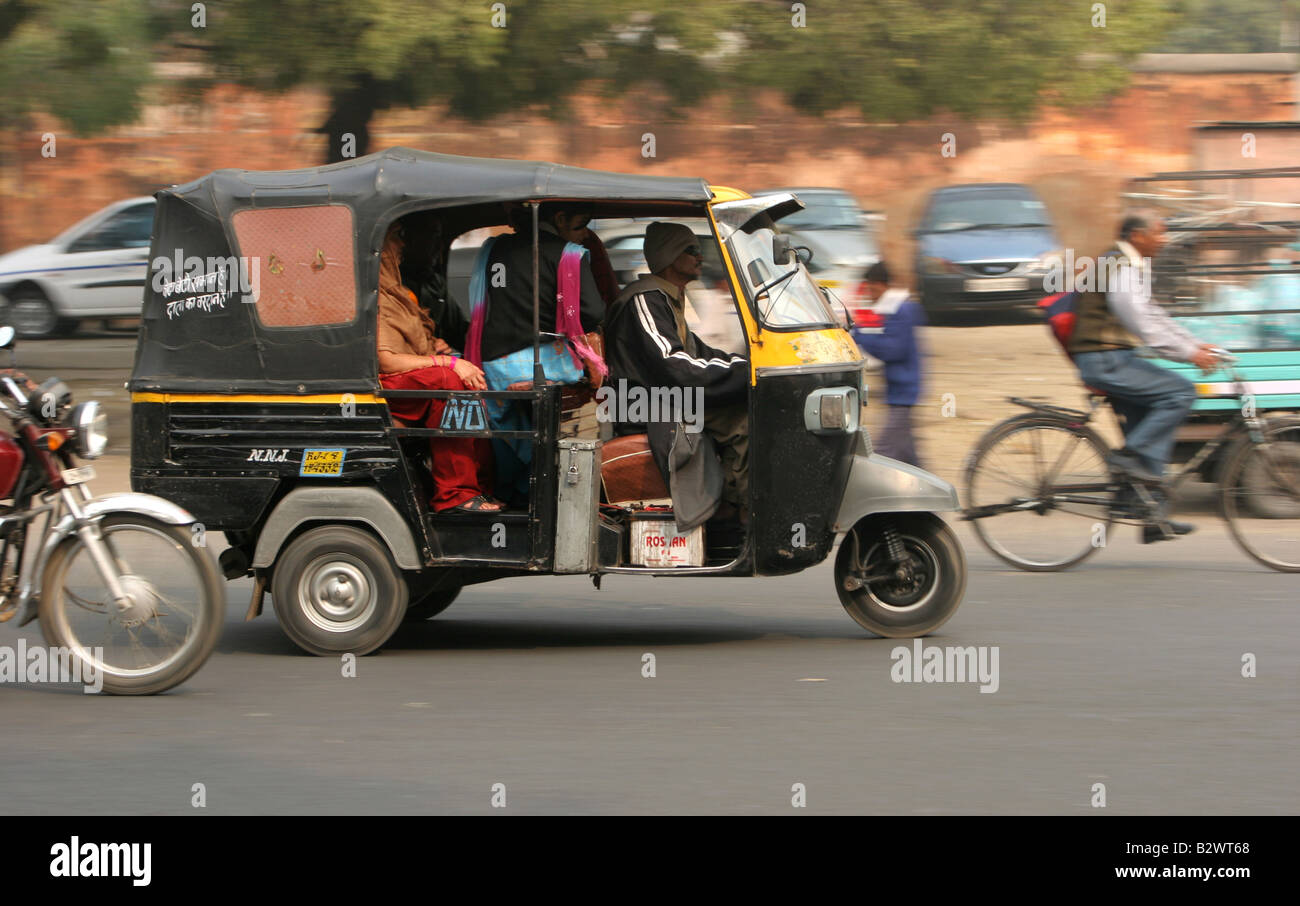 Tricycle auto rickshaw speeds up the MI Road Jaipur India Stock Photo ...