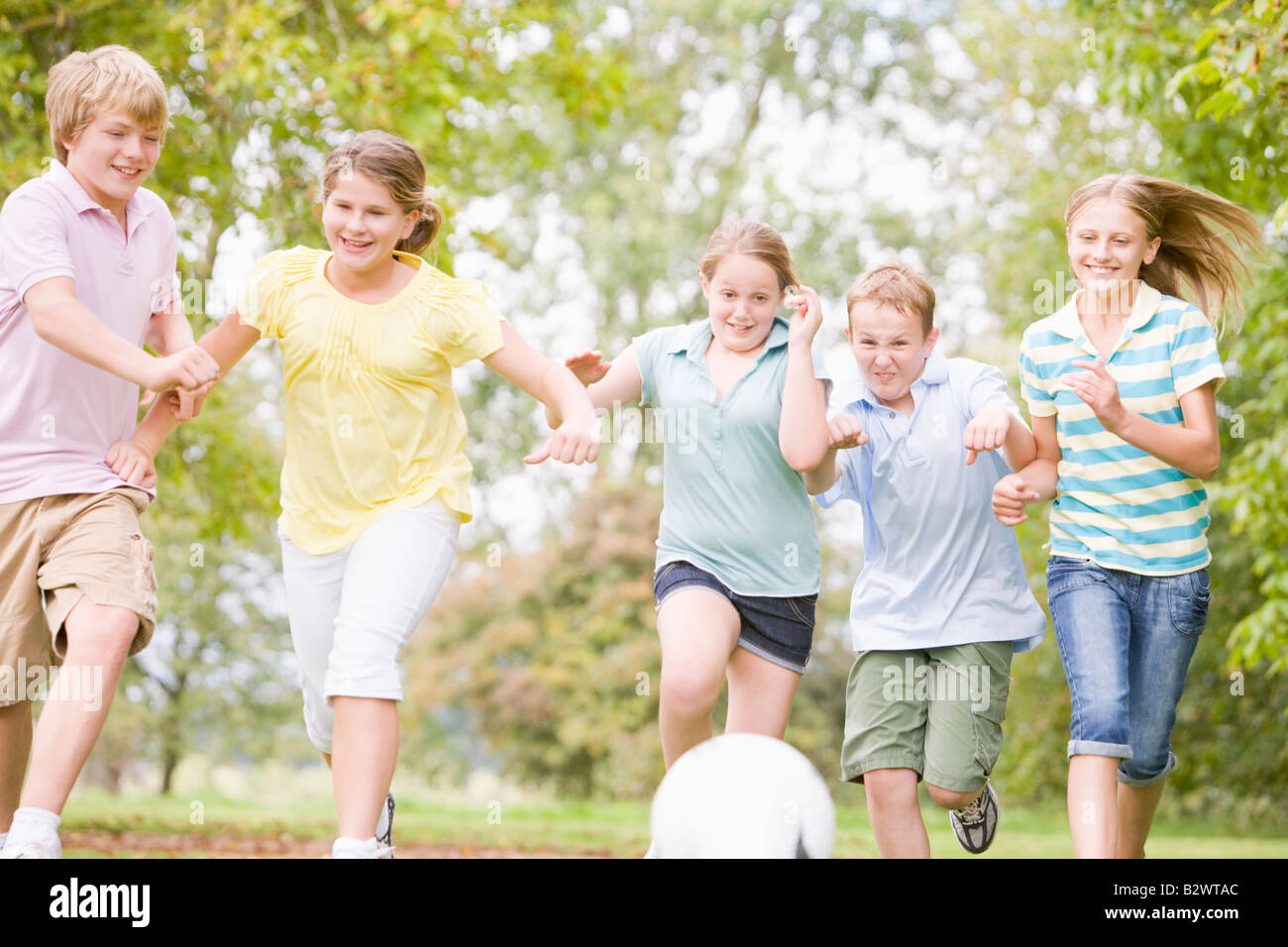 Five young friends playing soccer Stock Photo - Alamy
