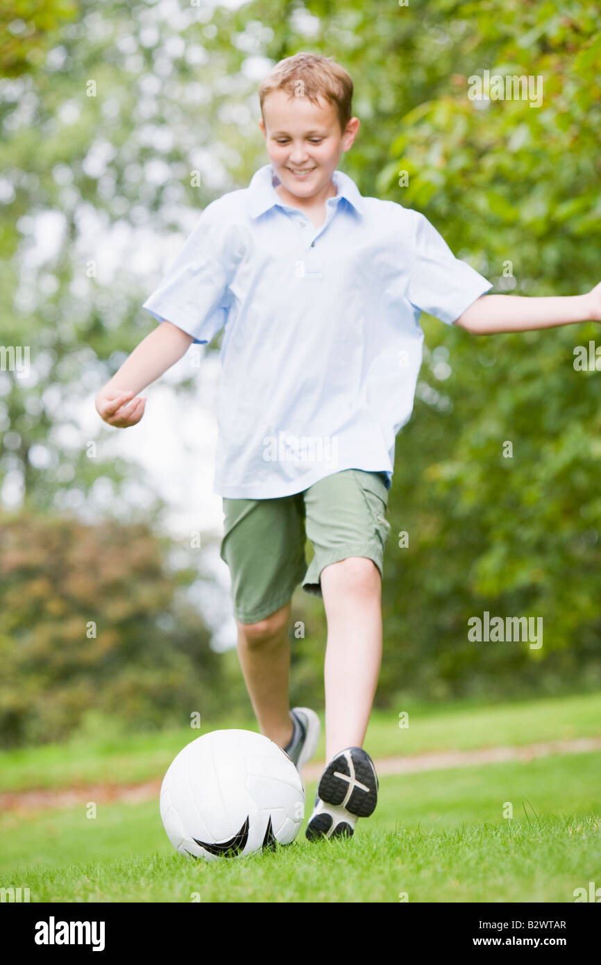Young boy playing soccer Stock Photo - Alamy