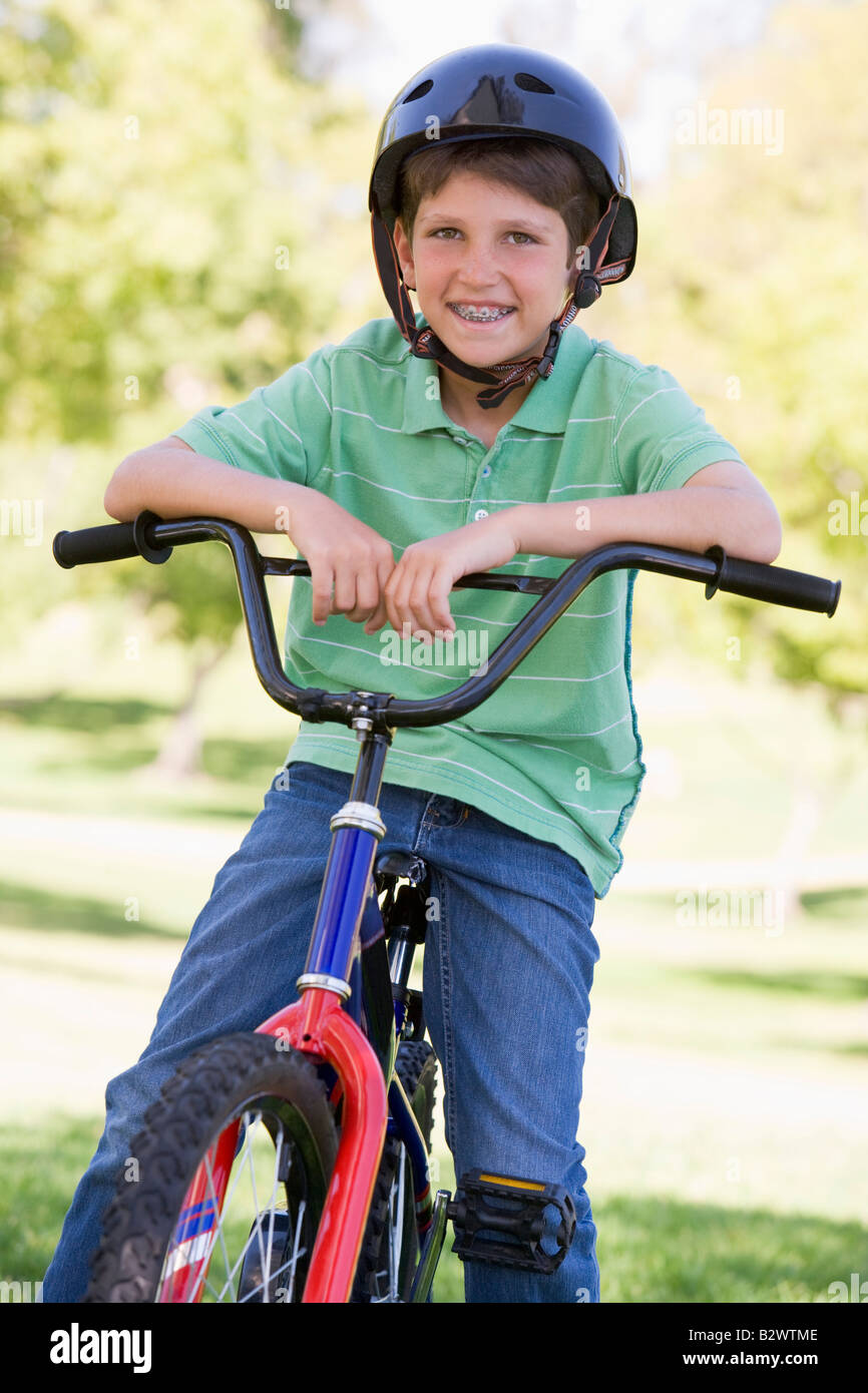 Young boy on bicycle outdoors smiling Stock Photo - Alamy