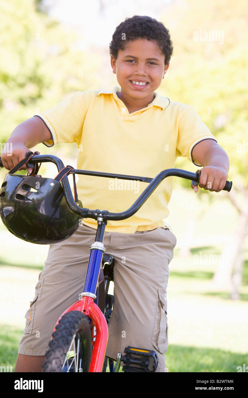 Young boy on bicycle outdoors smiling Stock Photo - Alamy