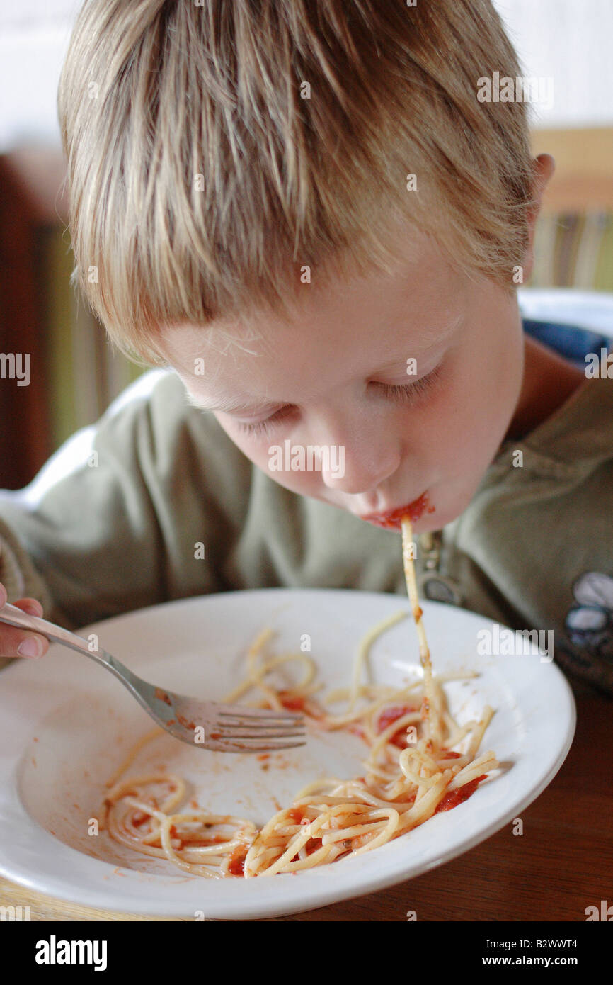 Boy eating noodles Stock Photo - Alamy