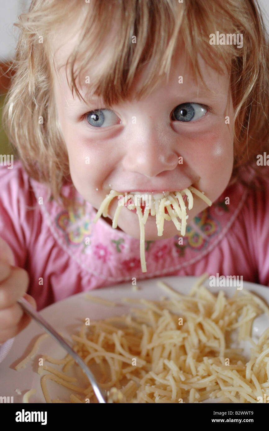 Girl eating noodles Stock Photo - Alamy