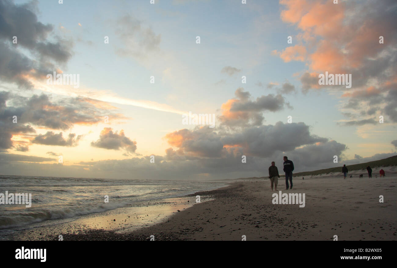 Holidaymakers on a beach at sunset Stock Photo - Alamy