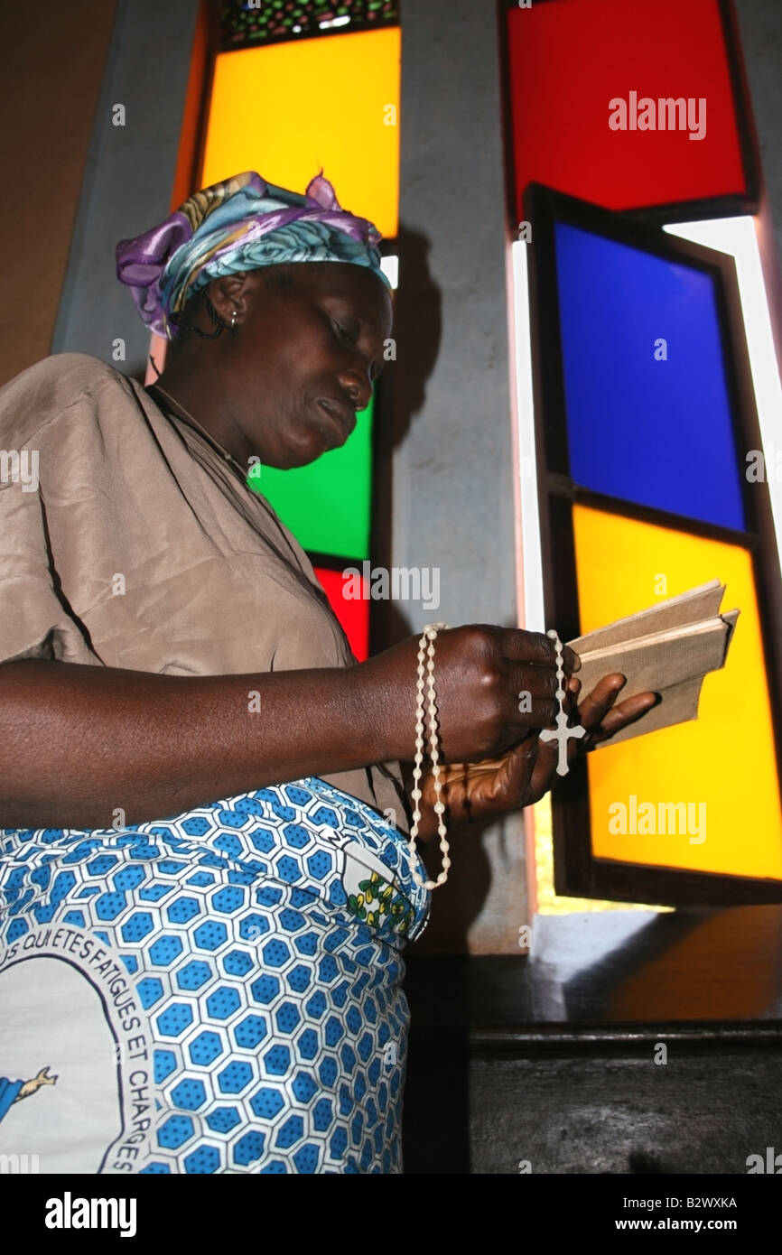 Lady reading a bible at a Catholic Church in Togo, West Africa Stock ...