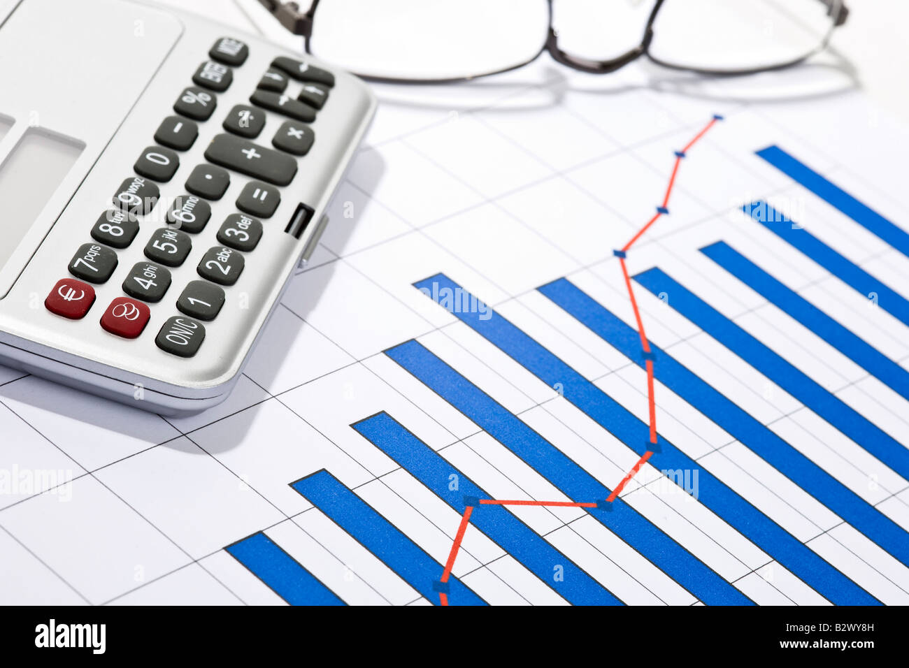 Bar chart on white paper with glasses and pen Stock Photo - Alamy