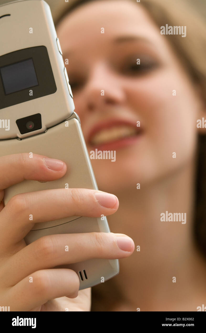 An adolescent caucasian girl using a cell phone. Shot with minimum ...
