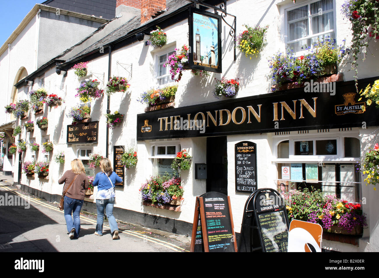 The London Inn, quaint English pub with many hanging baskets decorating ...