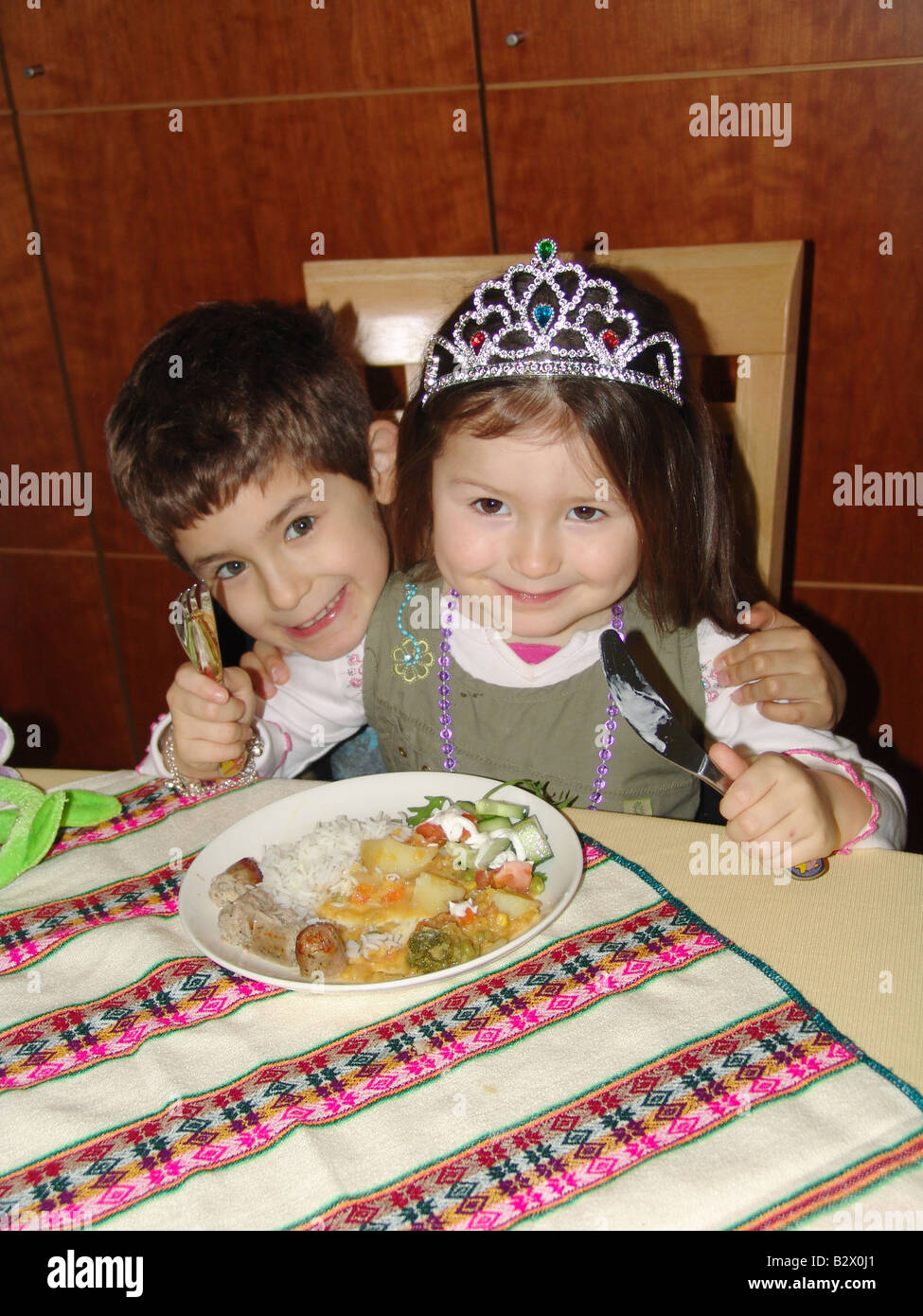 Two children having their dinner Stock Photo - Alamy