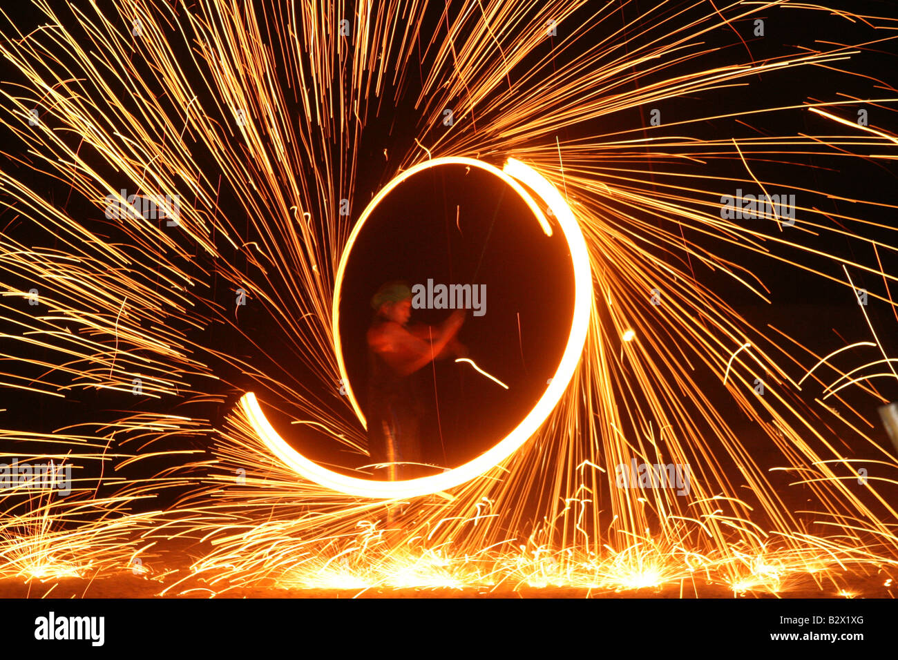 A young Moroccan boy juggling with fire at an event in the desert near ...