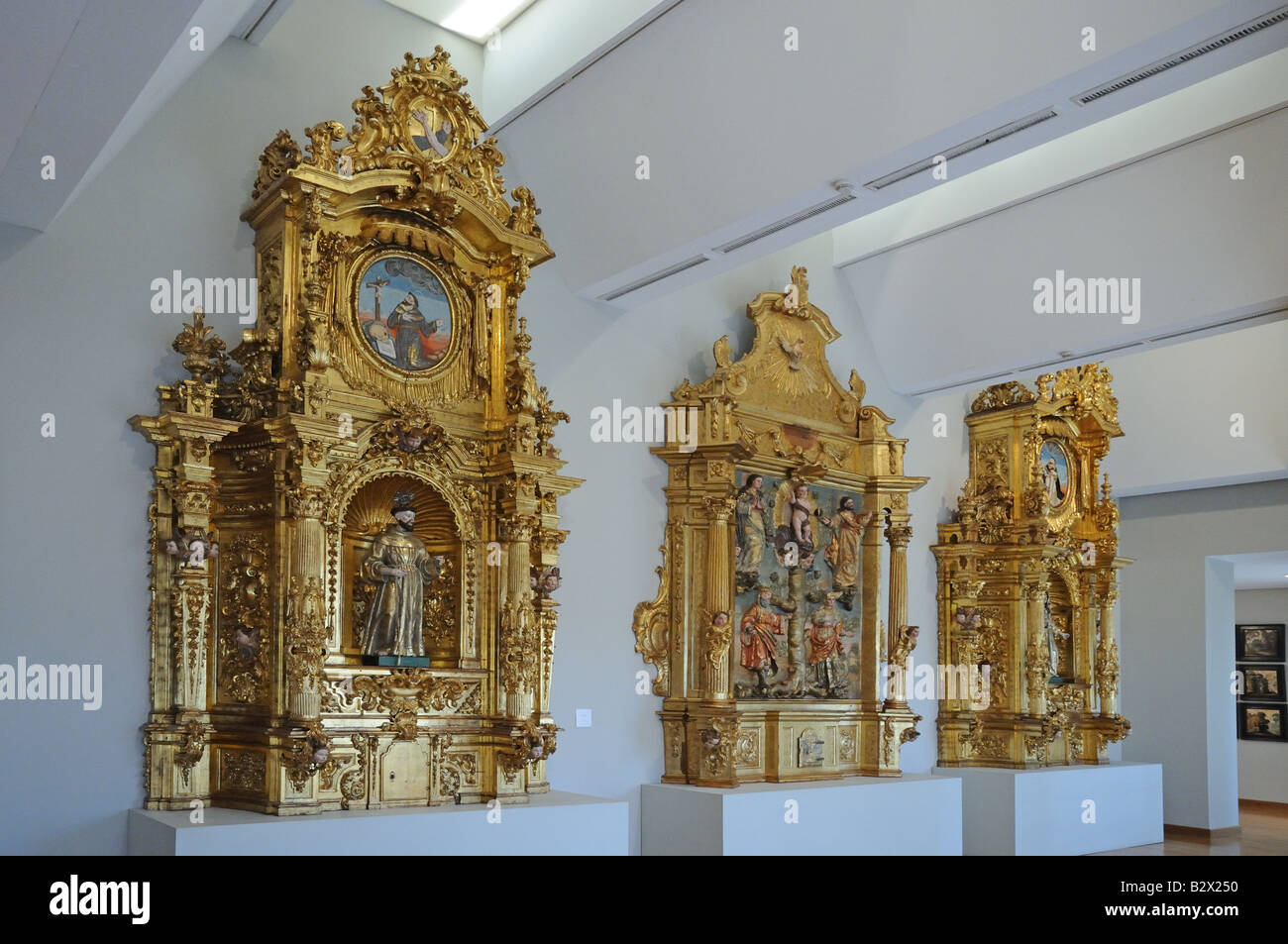 Three guilded ornate wooden altarpieces The nearest dedicated to Saint ...