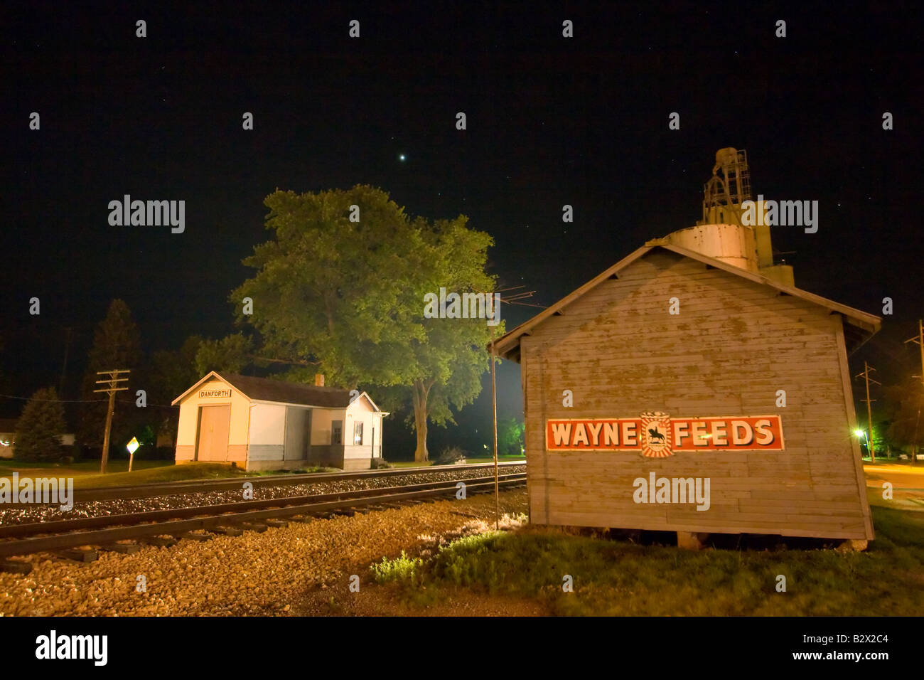 A train is approaching the small depot and grain elevator in downtown ...