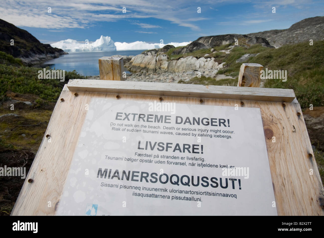 A sign warning of tsunami waves from collapsing and rolling icebergs in ...