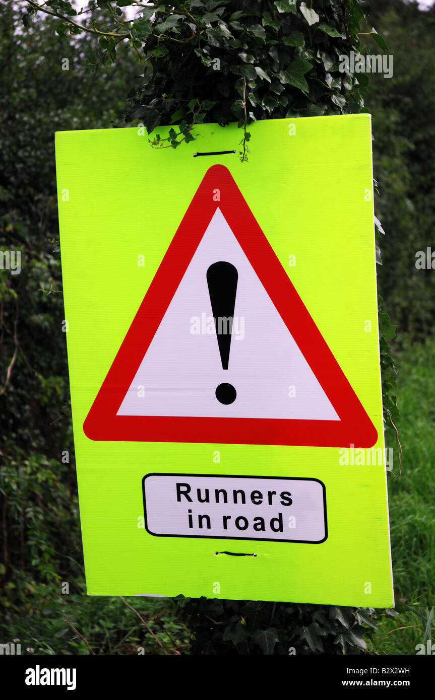Warning sign, runners in road Stock Photo - Alamy