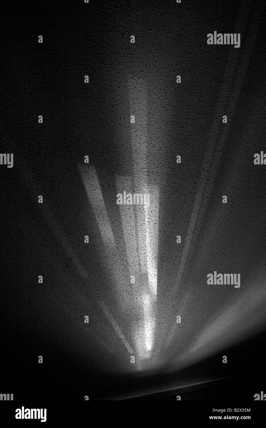 Light cascades through a slit in long geometric shapes Stock Photo - Alamy