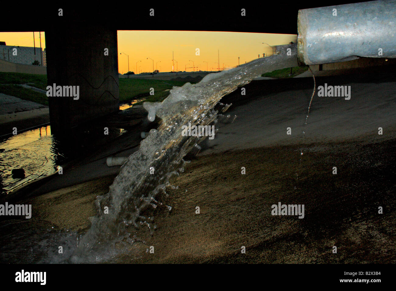 Water flowing from drain pipe Stock Photo - Alamy