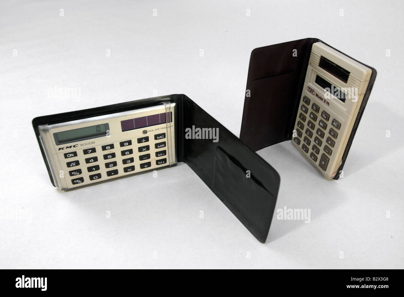 Two solar-powered calculators with dark brown vinyl soft cases Stock ...