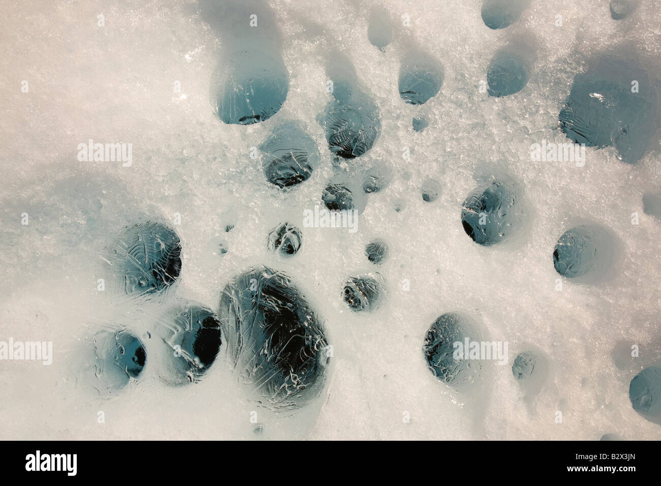 Melt water holes on the Greenland ice sheet near camp Victor north of ...