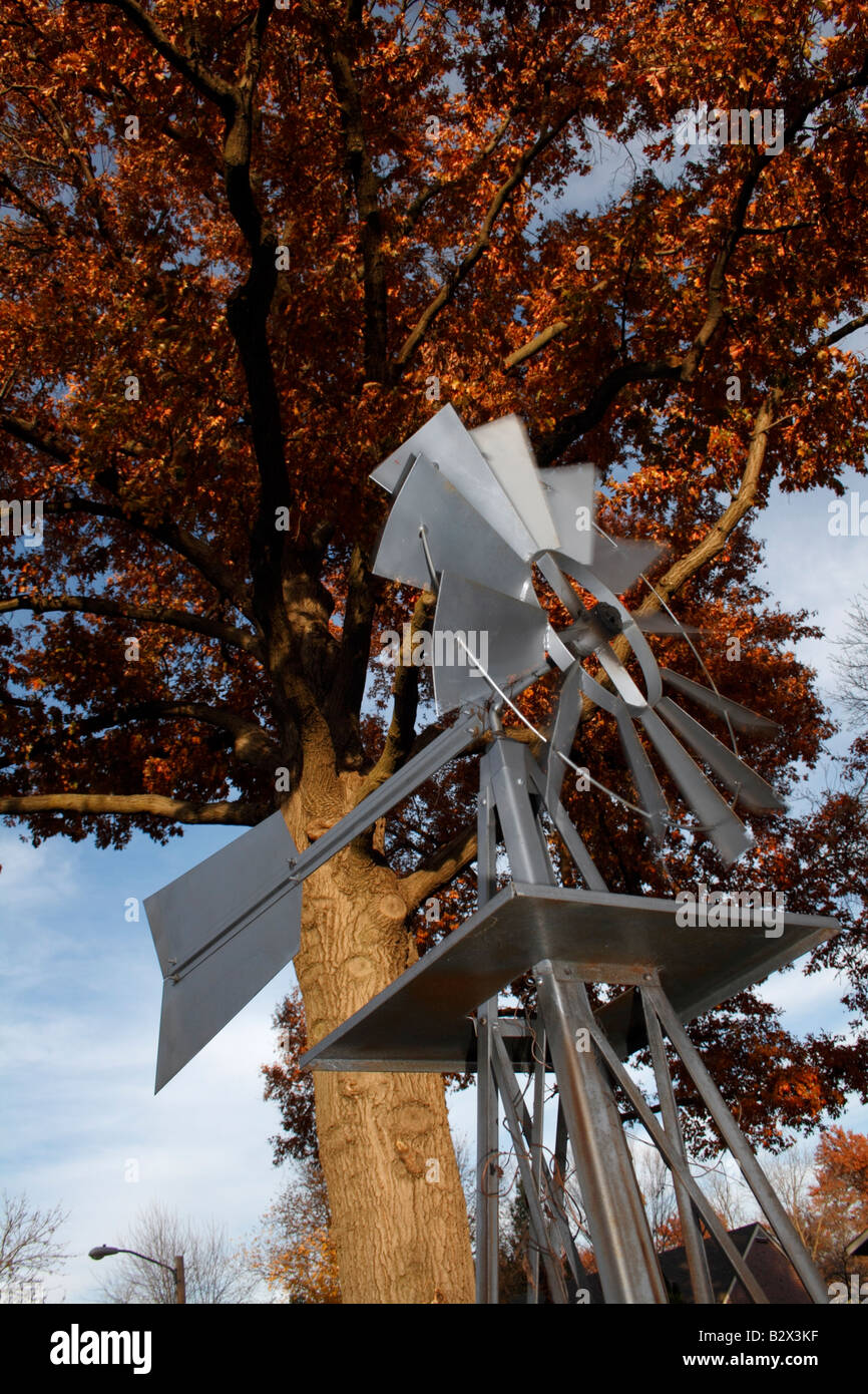 Windmill turning in the breeze with red autumn oak leaves Stock Photo ...