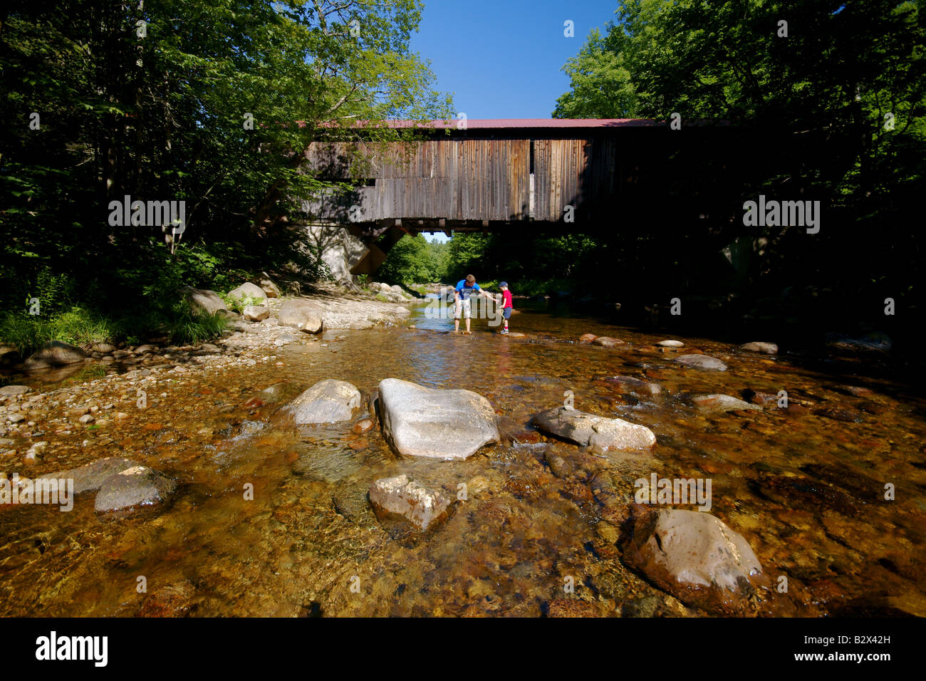 Children playing under the Durgin Covered Bridge which is built over ...