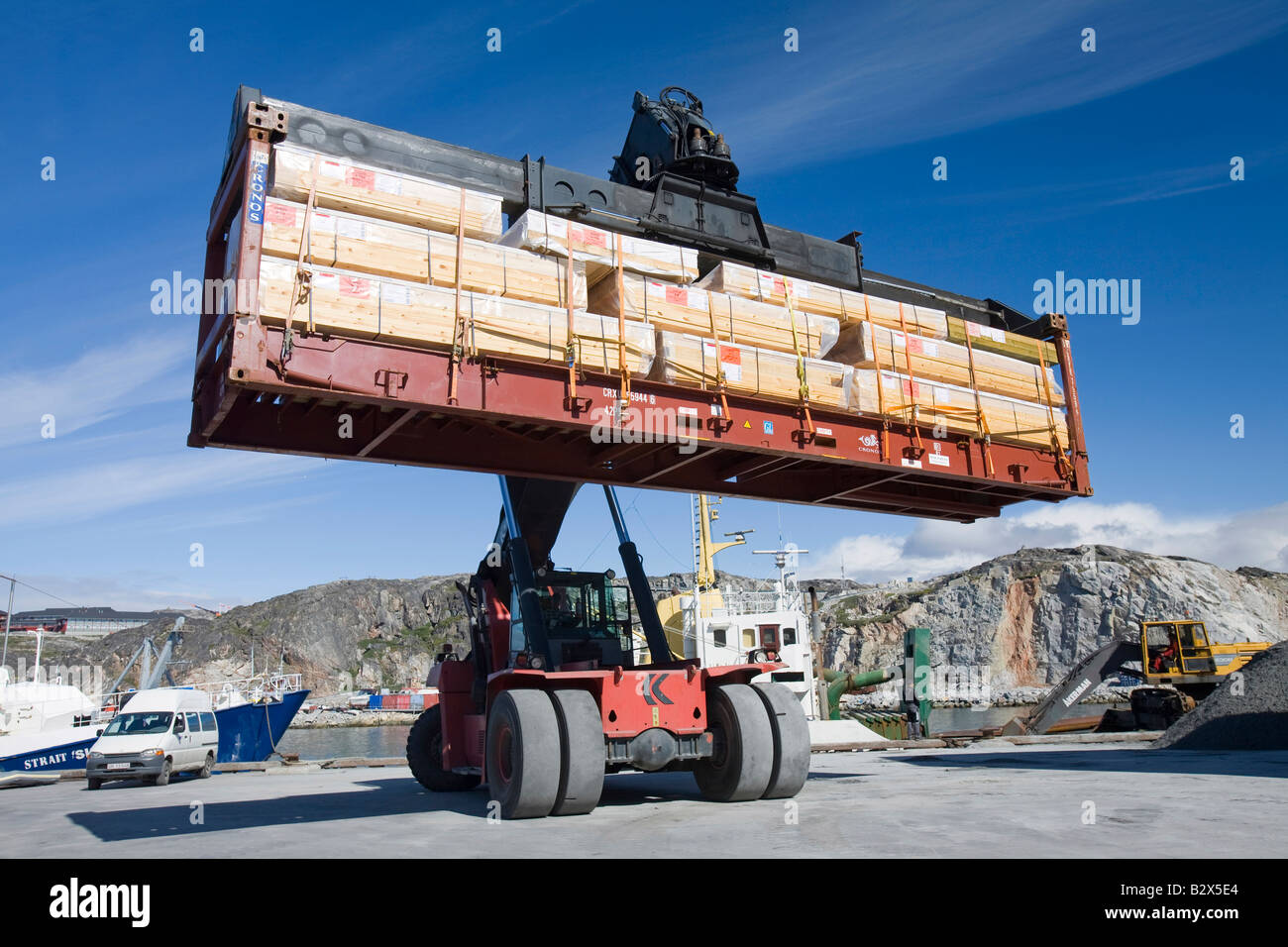 Moving freight containers around at Ilulissat dock on Greenland Stock ...