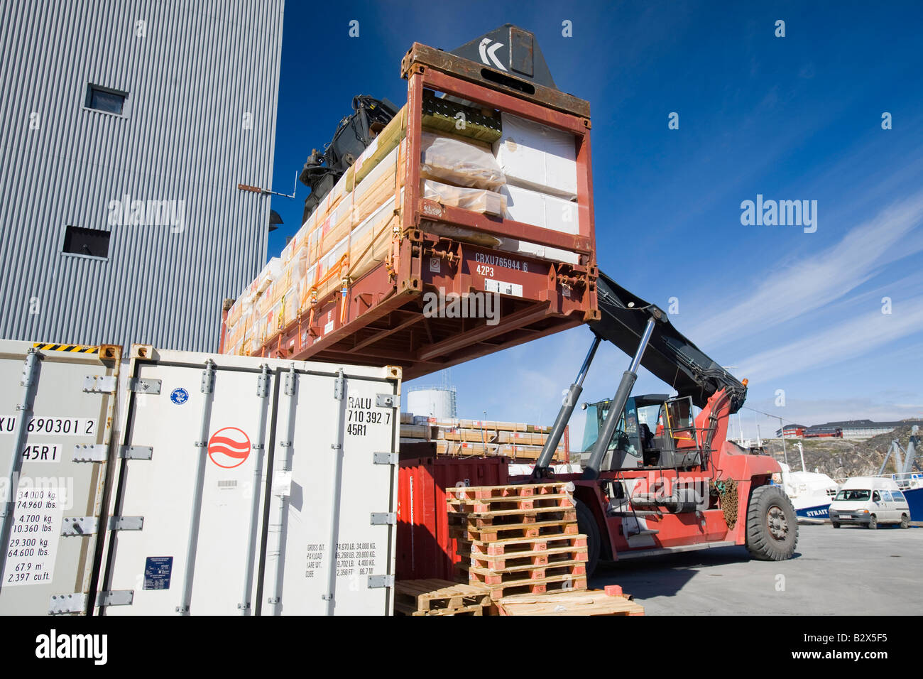 Moving freight containers around at Ilulissat dock on Greenland Stock ...