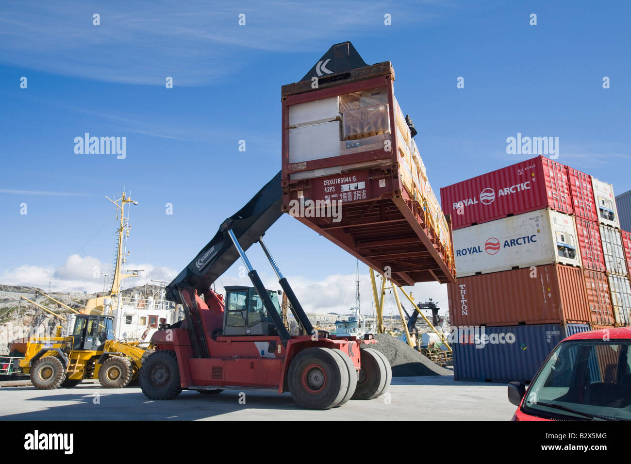 Moving freight containers around at Ilulissat dock on Greenland Stock ...