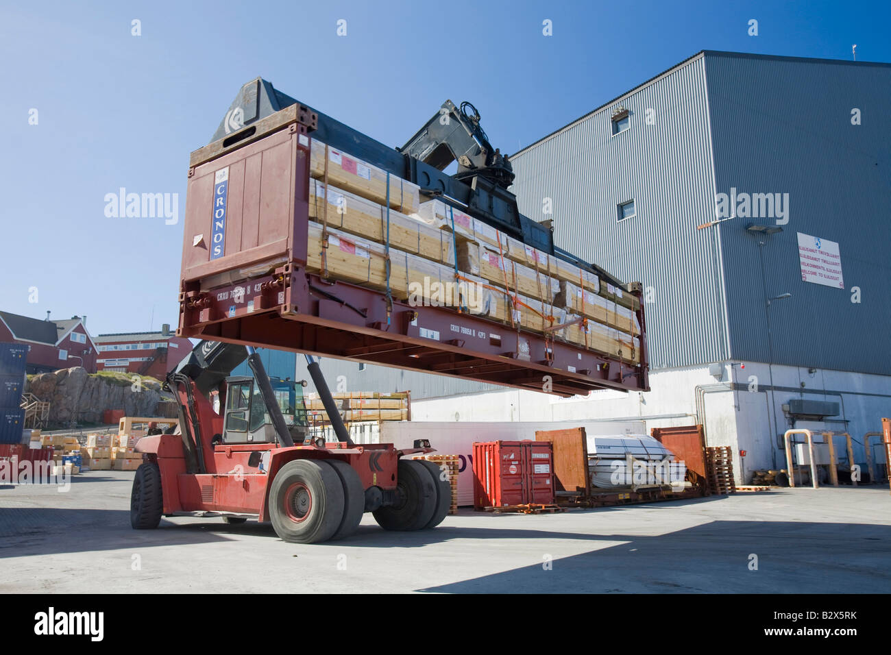 Moving freight containers around at Ilulissat dock on Greenland Stock ...