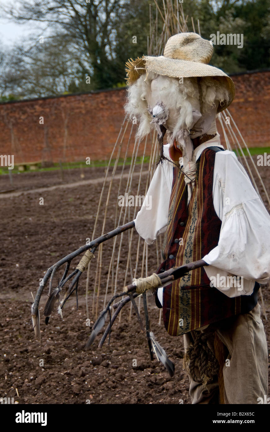 A scarecrow dressed in 18th century clothing stands in the walled ...