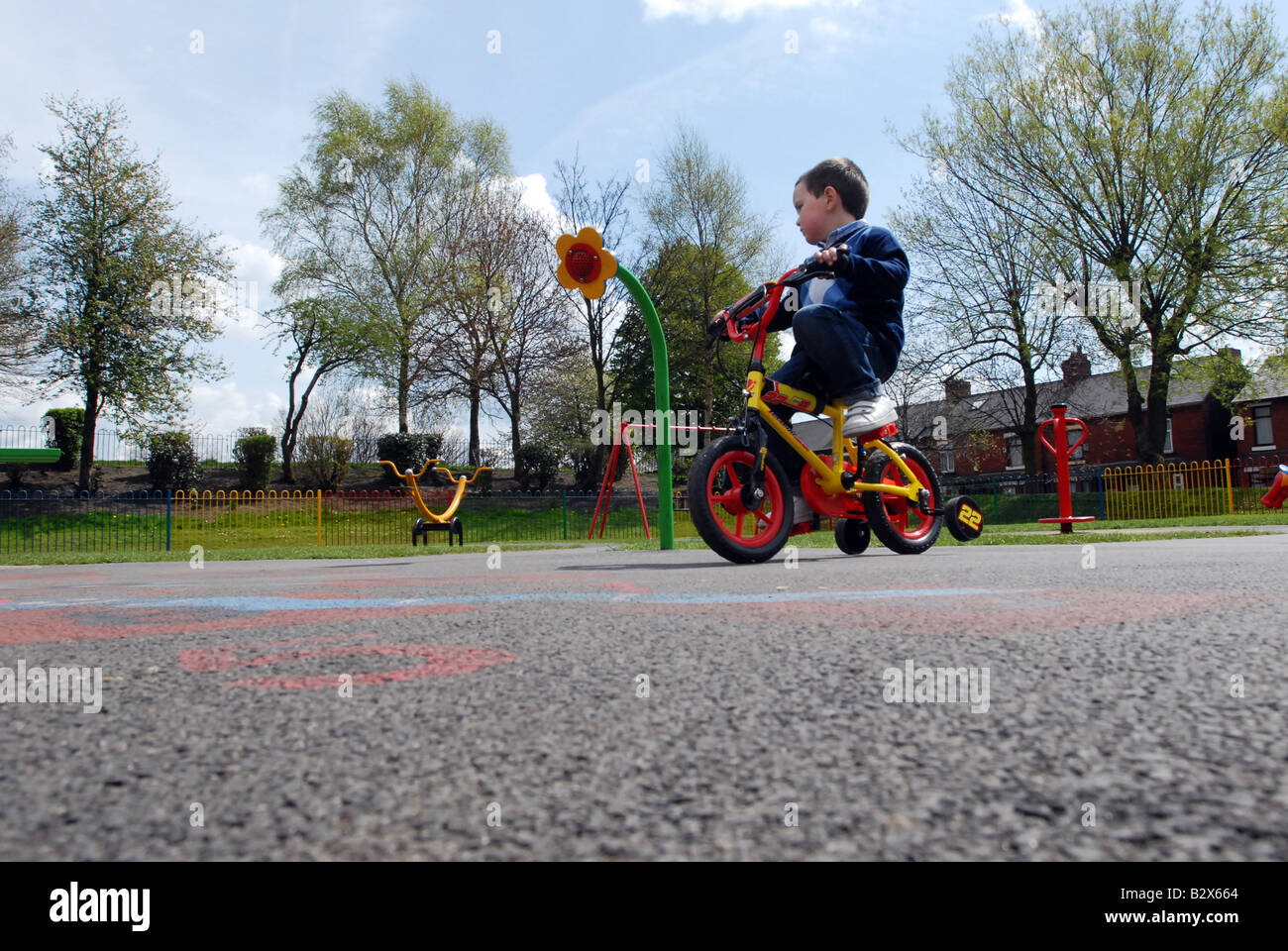 Young boy cycling in playground Stock Photo - Alamy