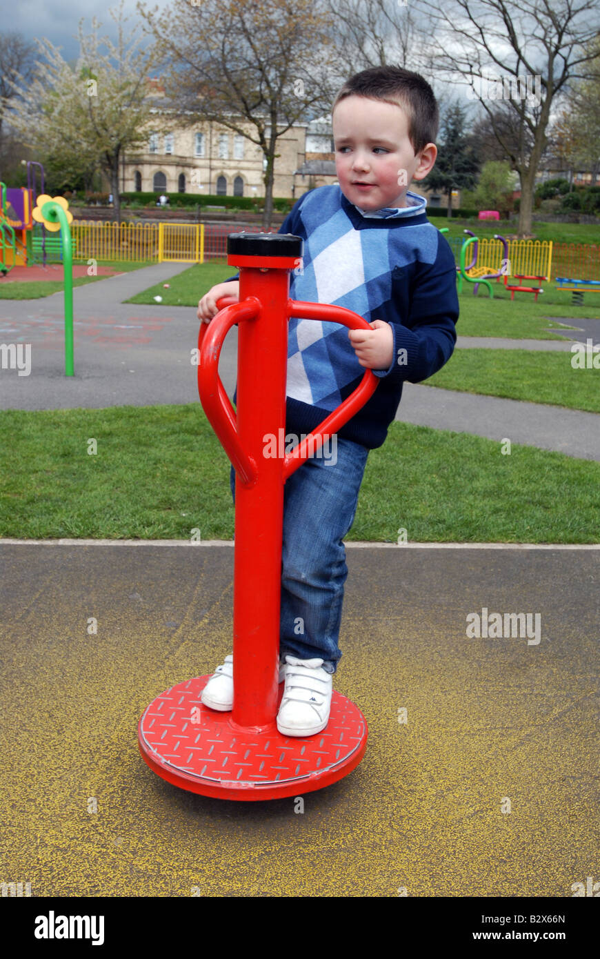 Child on Roundabout Stock Photo - Alamy
