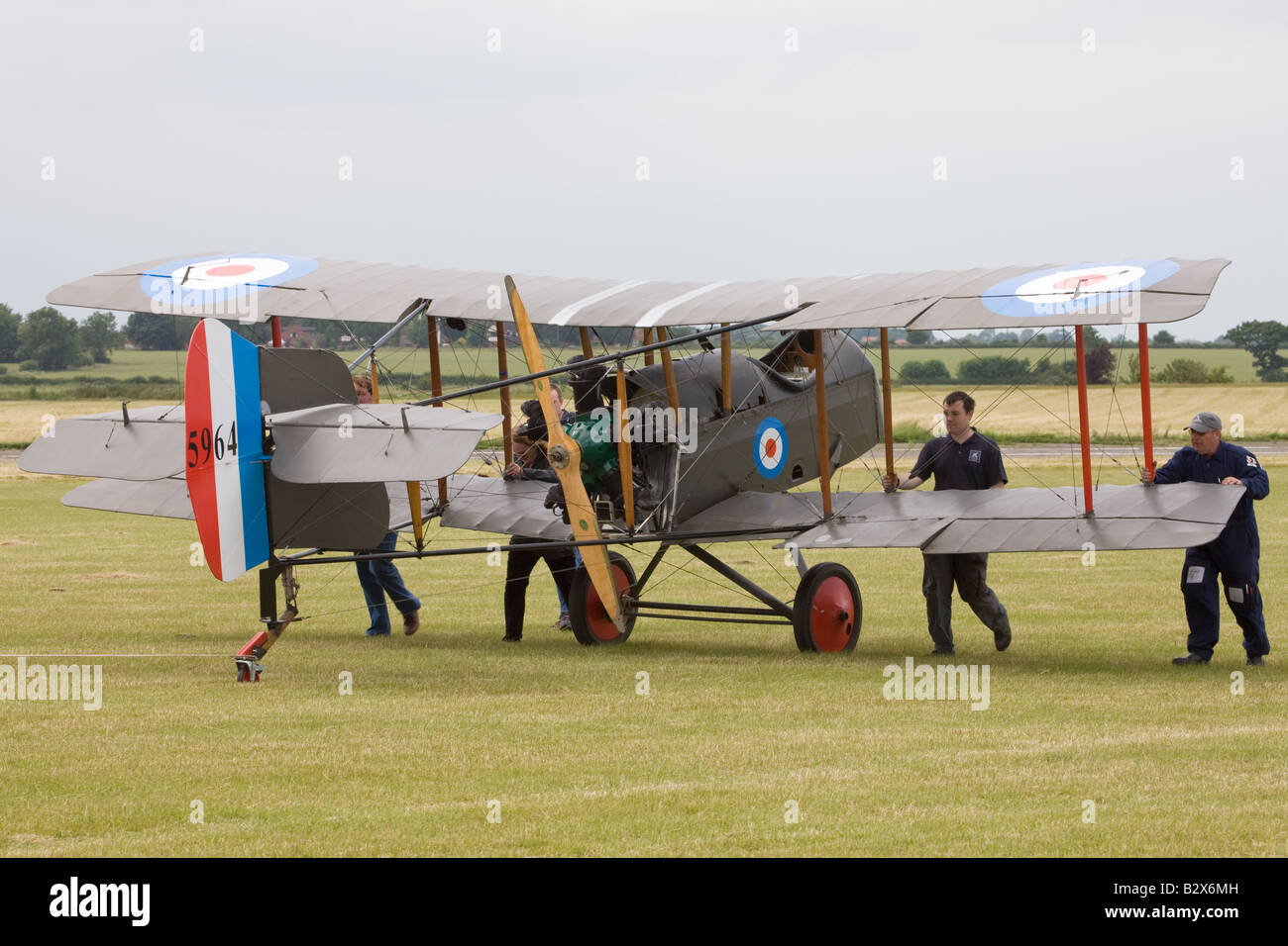DH-2 Replica 5964 G-BFGH being pushed along grass by ground handlers at ...