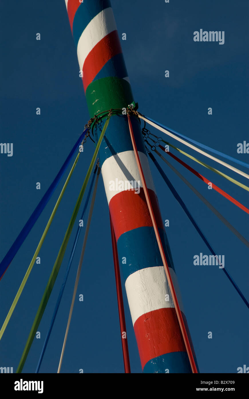 Brightly painted May Pole with ribbons attached. Used to perfom ...