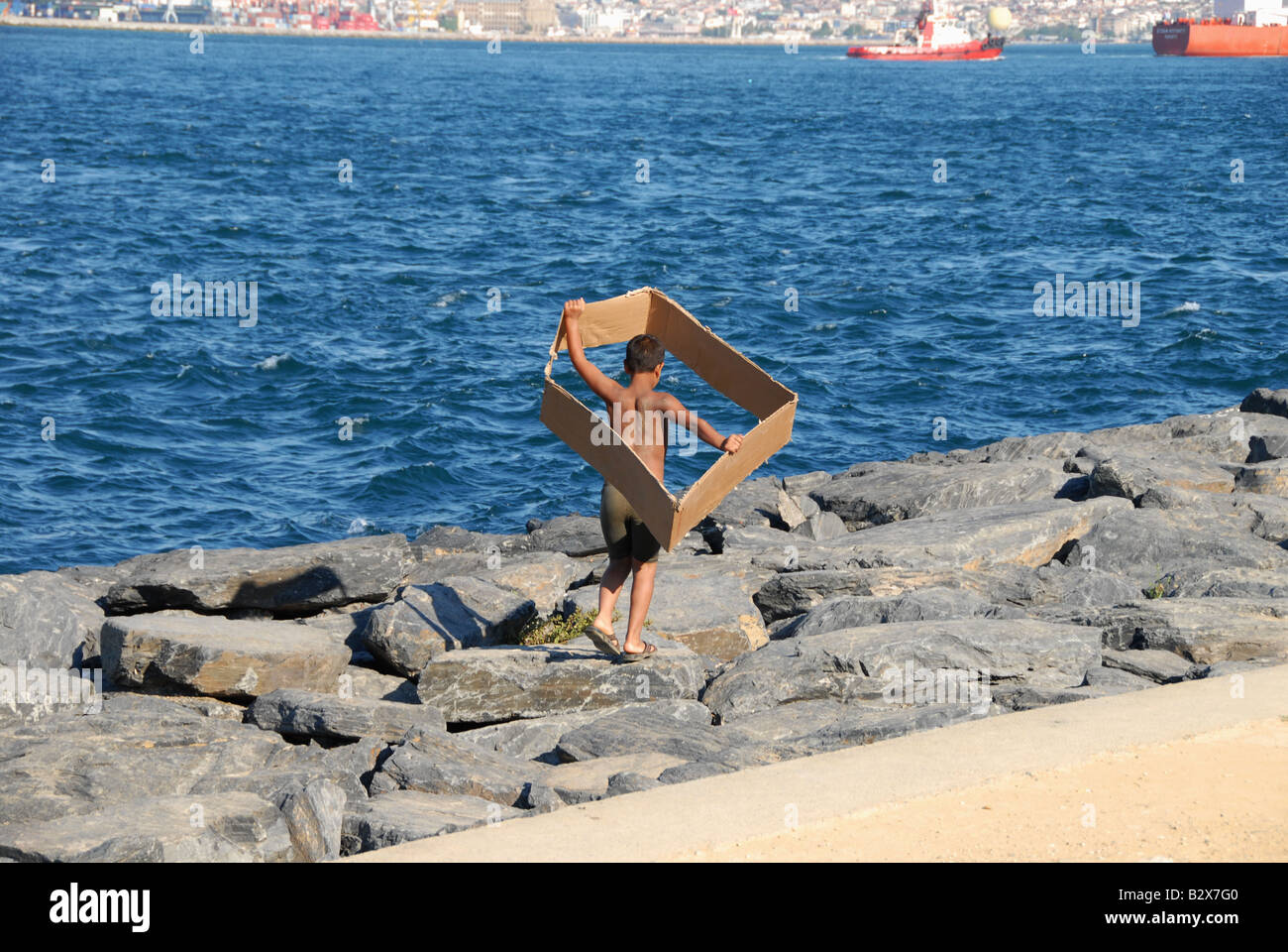 young boy playing with a box Stock Photo - Alamy