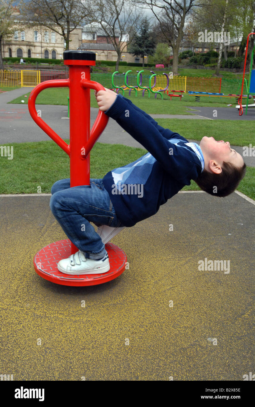 Child on Roundabout Stock Photo - Alamy
