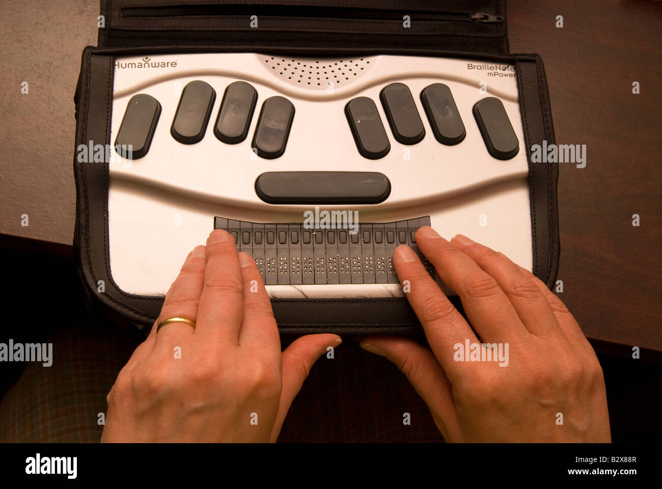 Blind woman using Braille Note machine, basically a laptop, for people ...