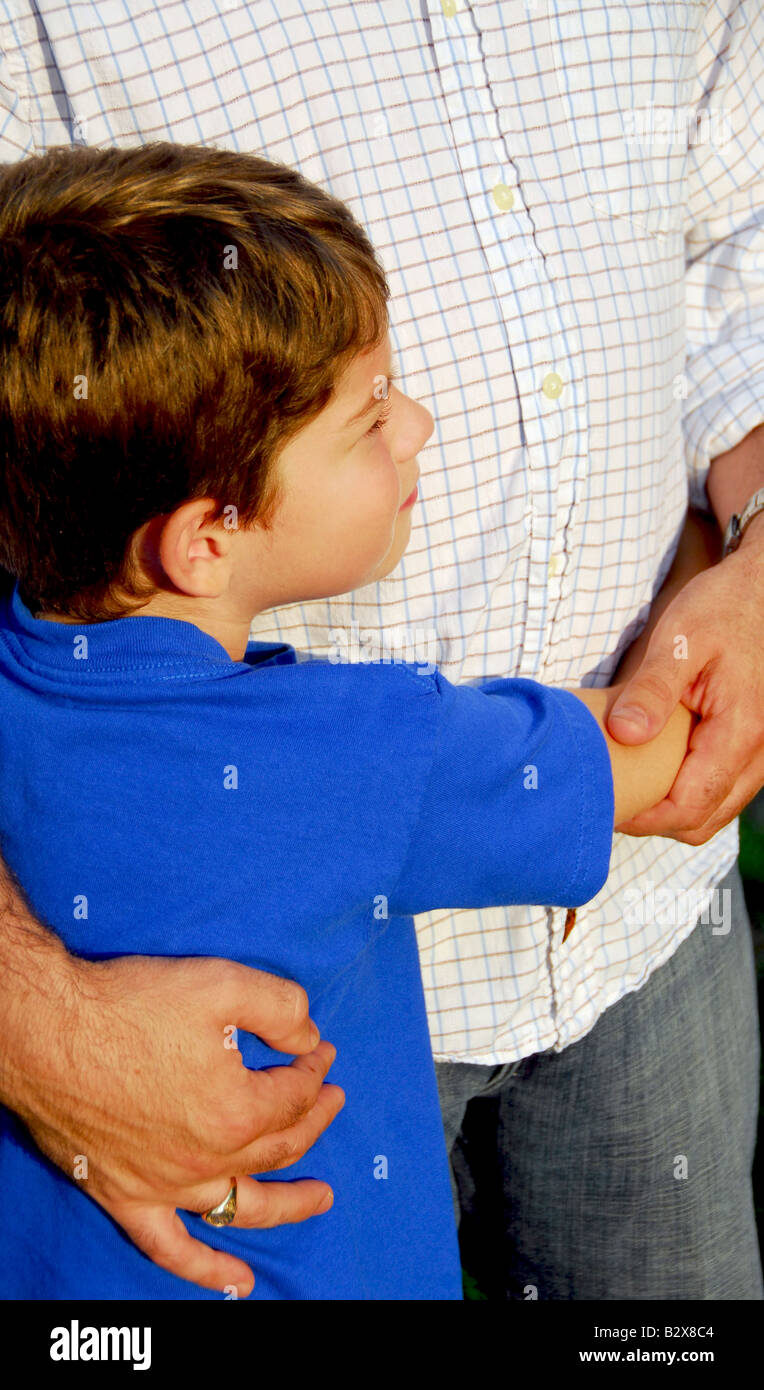 Little boy hugging his father Stock Photo - Alamy
