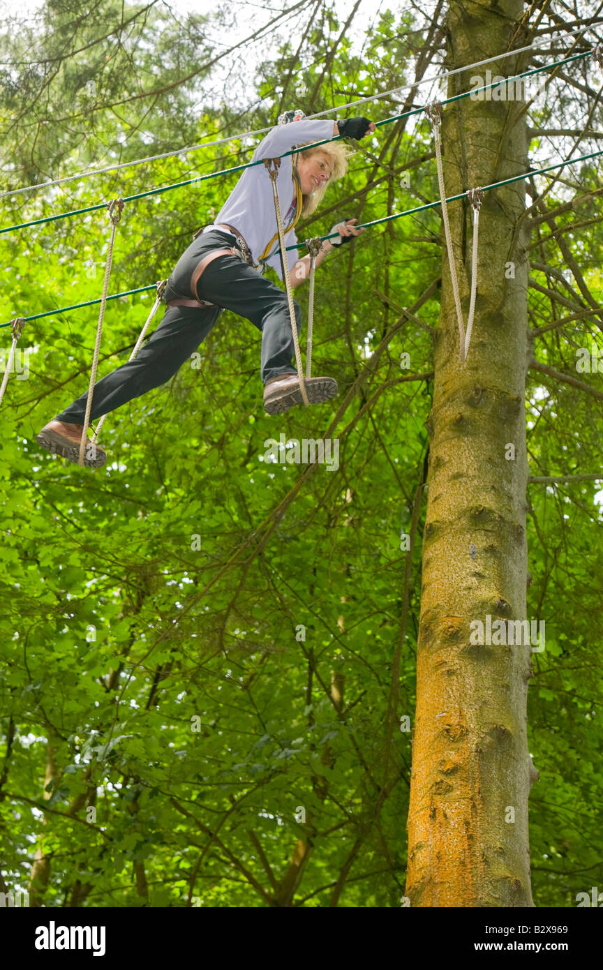 A women on the the Go Ape aerial challenge in Grizedale Forest in ...