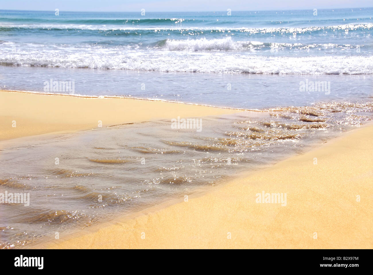 Ocean shore with sandy beach and small tributary Stock Photo - Alamy