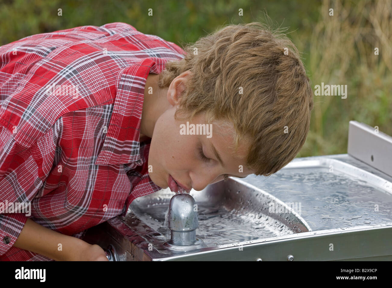 Boy drinking water fountain hi-res stock photography and images - Alamy