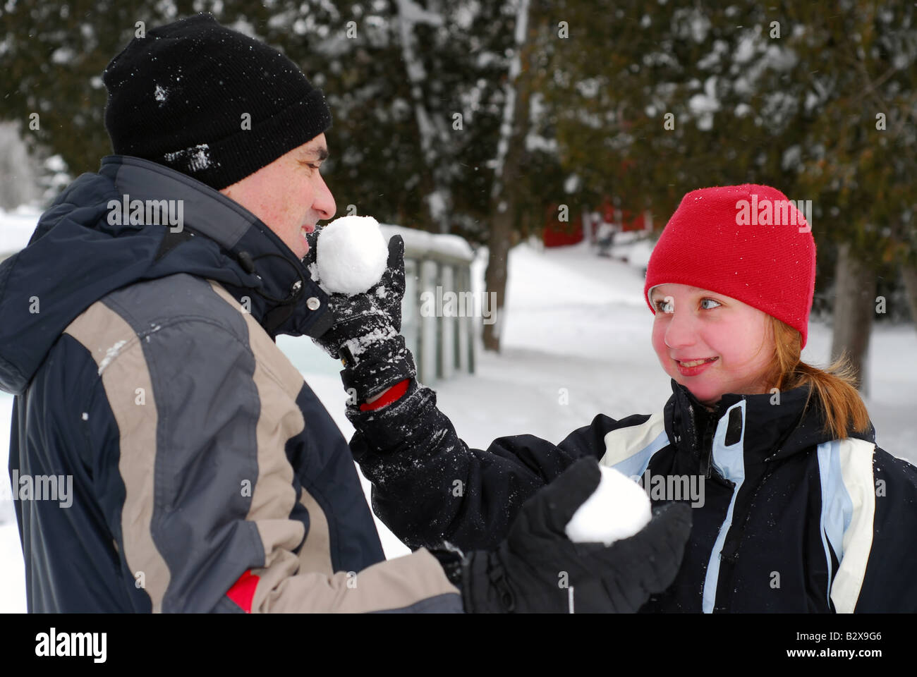 Father and child holding snowballs in winter park Stock Photo - Alamy
