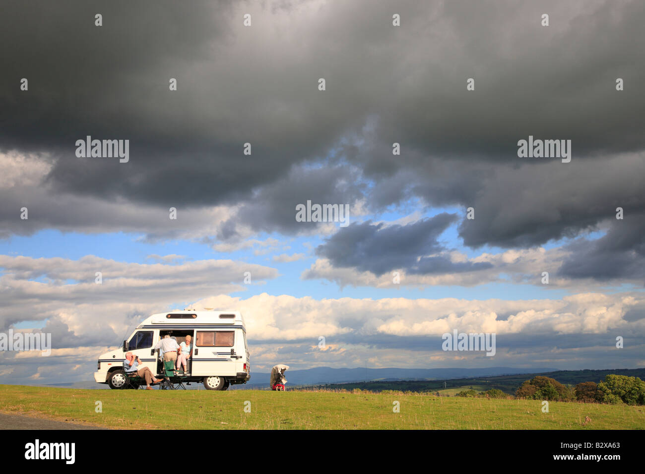 Camper van with four retired pensioners waiting for the rain to come ...