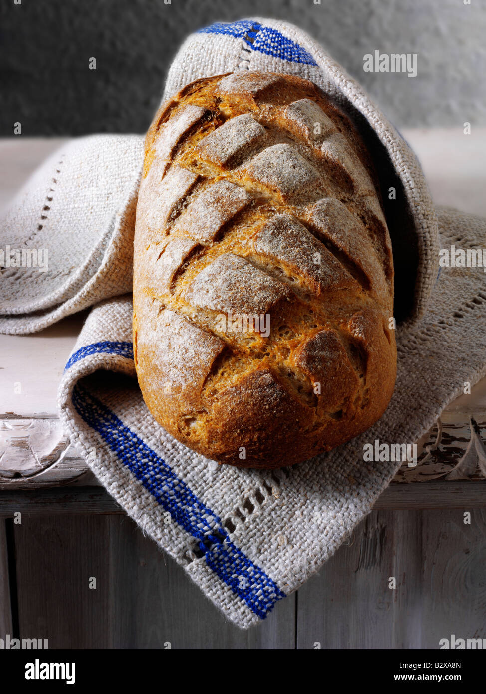 Sour Dough loaf of bread in a rustic setting on a table Stock Photo - Alamy